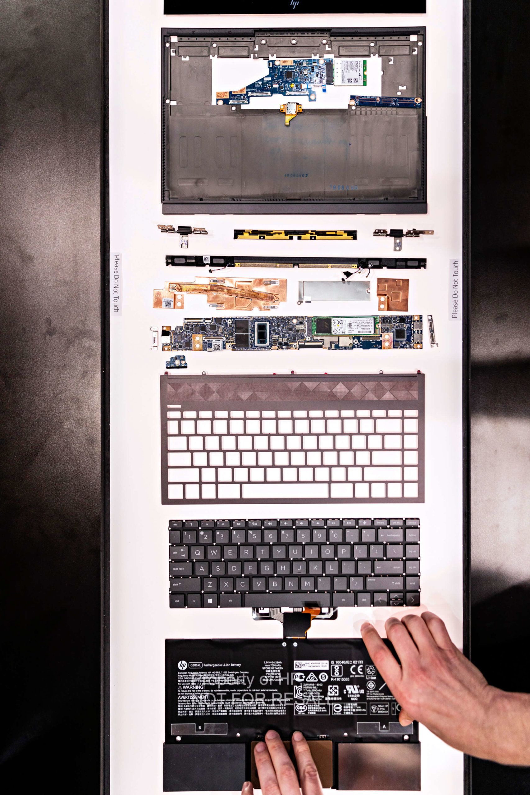 disassembled HP computer parts displayed as exploded view